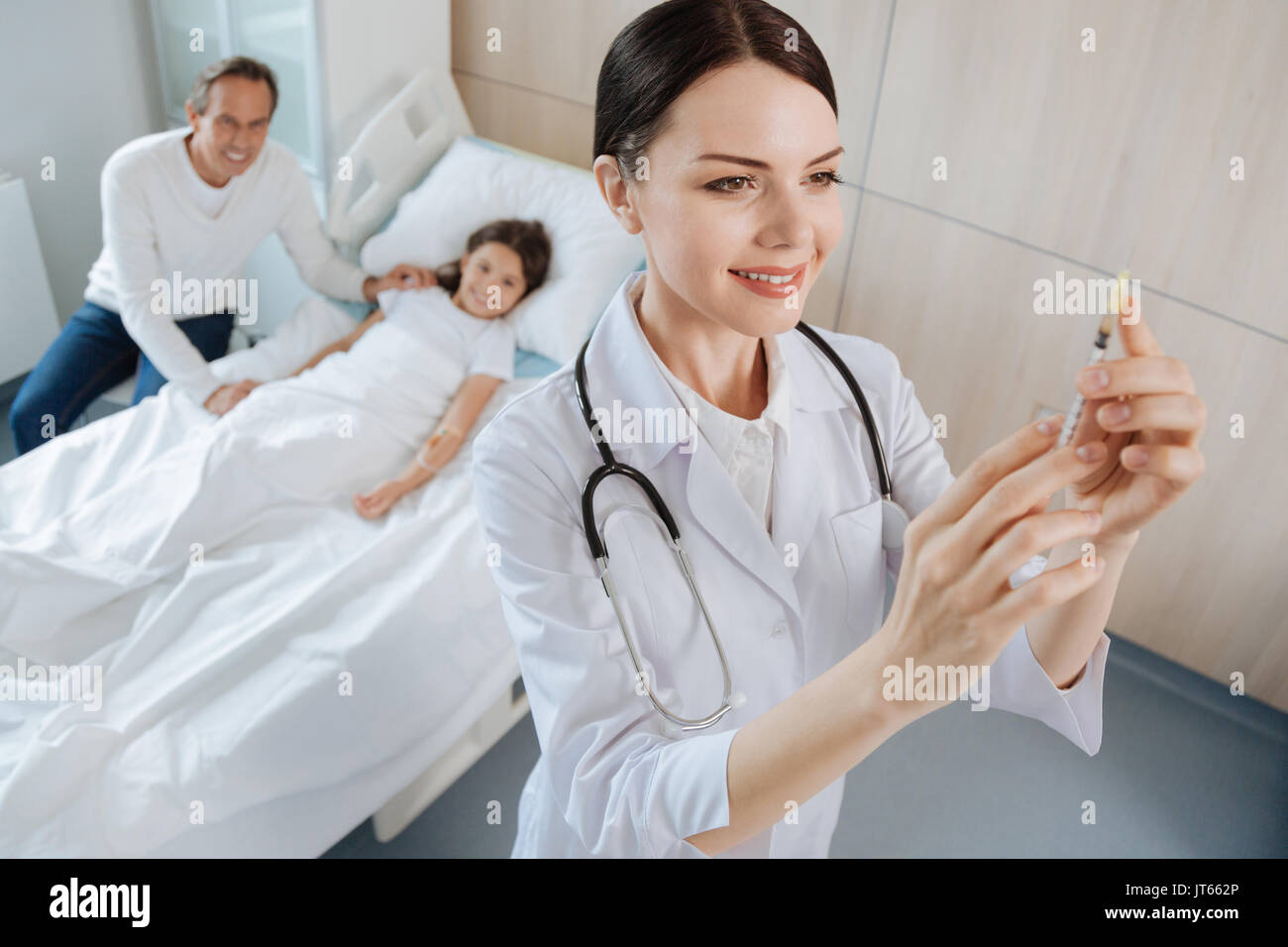 Cheerful positive doctor preparing for an injection Stock Photo - Alamy