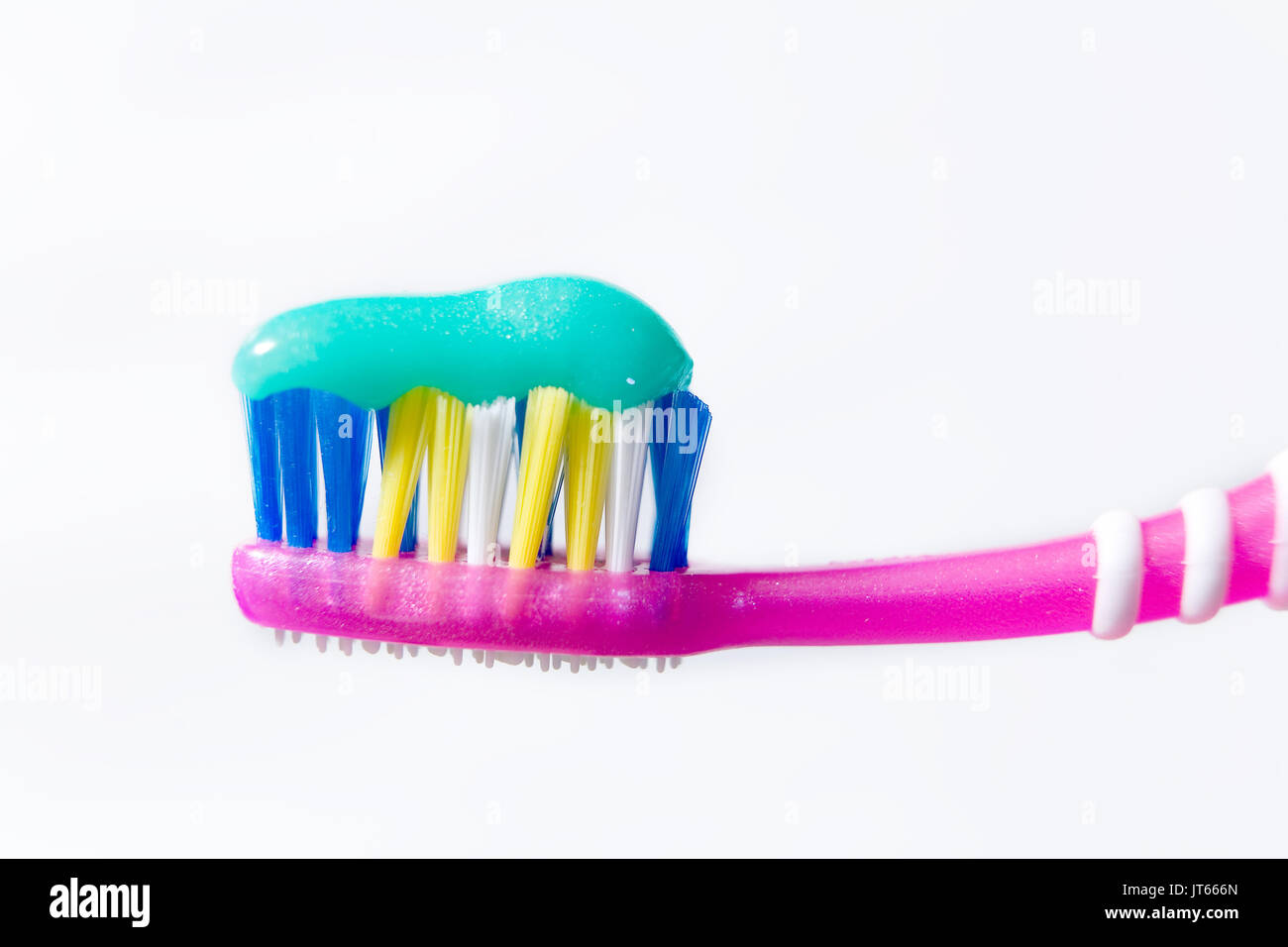 Multi-colored toothbrush on a white background. Close-up Stock Photo ...