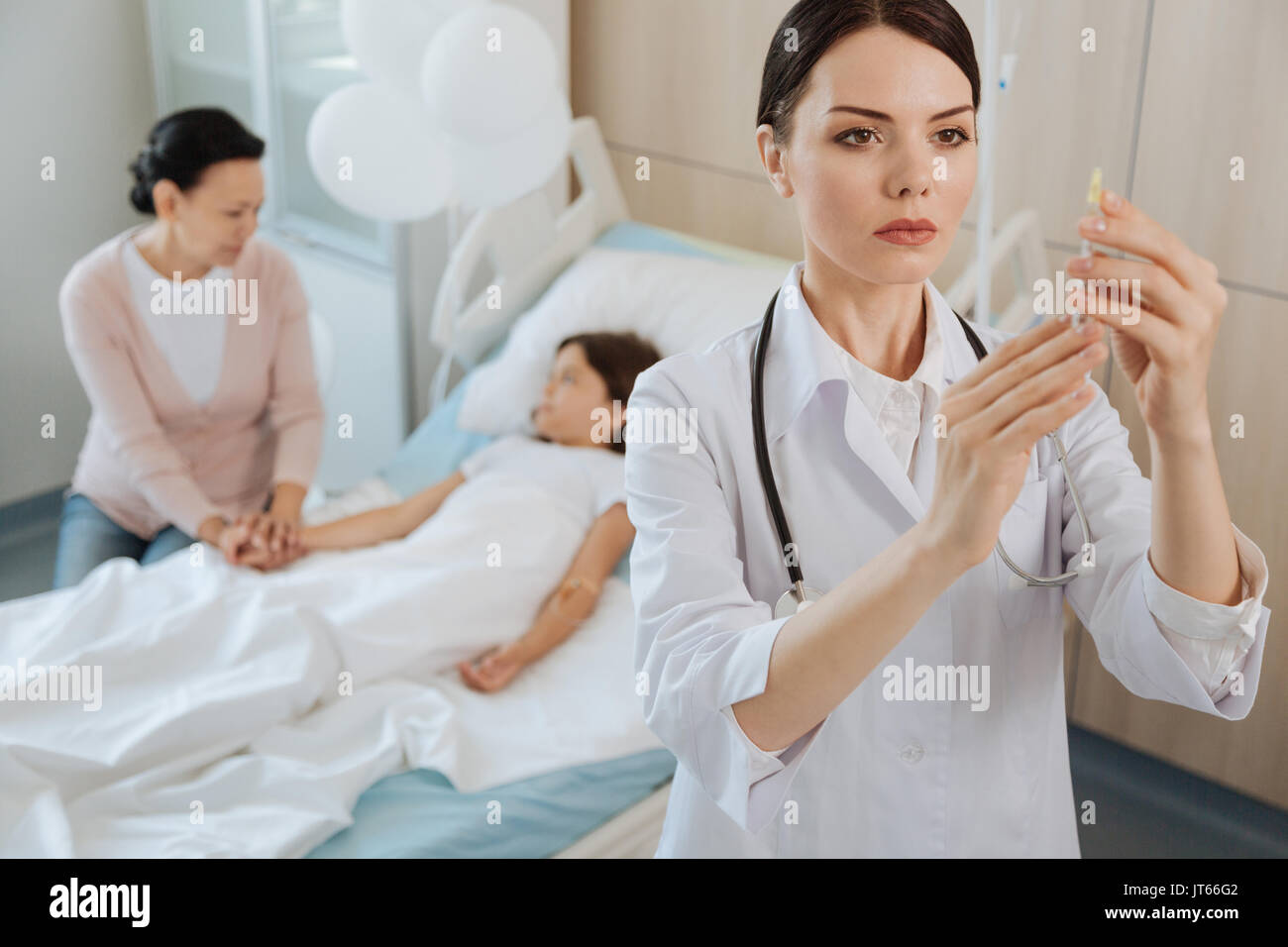 Smart serious doctor concentrating on her work Stock Photo - Alamy