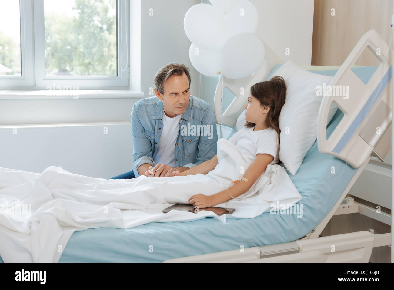Handsome caring father worrying about his daughter Stock Photo - Alamy