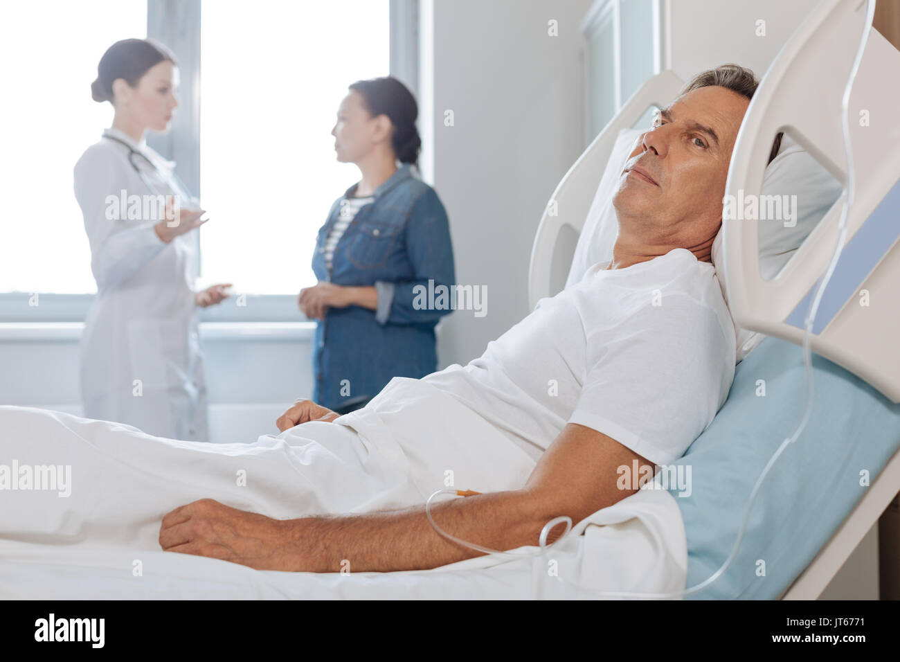 Pleasant middle aged man resting in his bed Stock Photo - Alamy