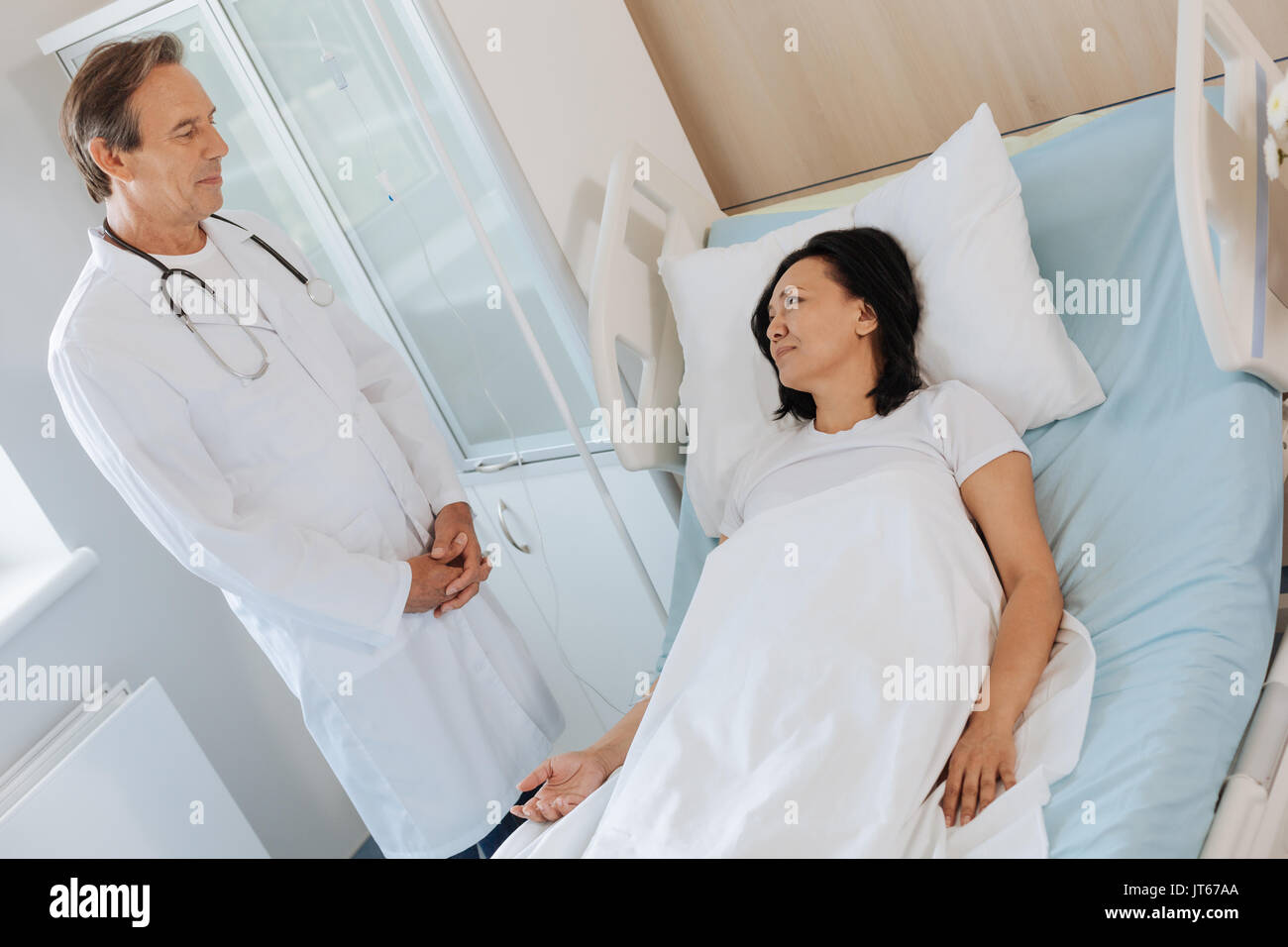 Positive professional doctor checking his patient Stock Photo - Alamy