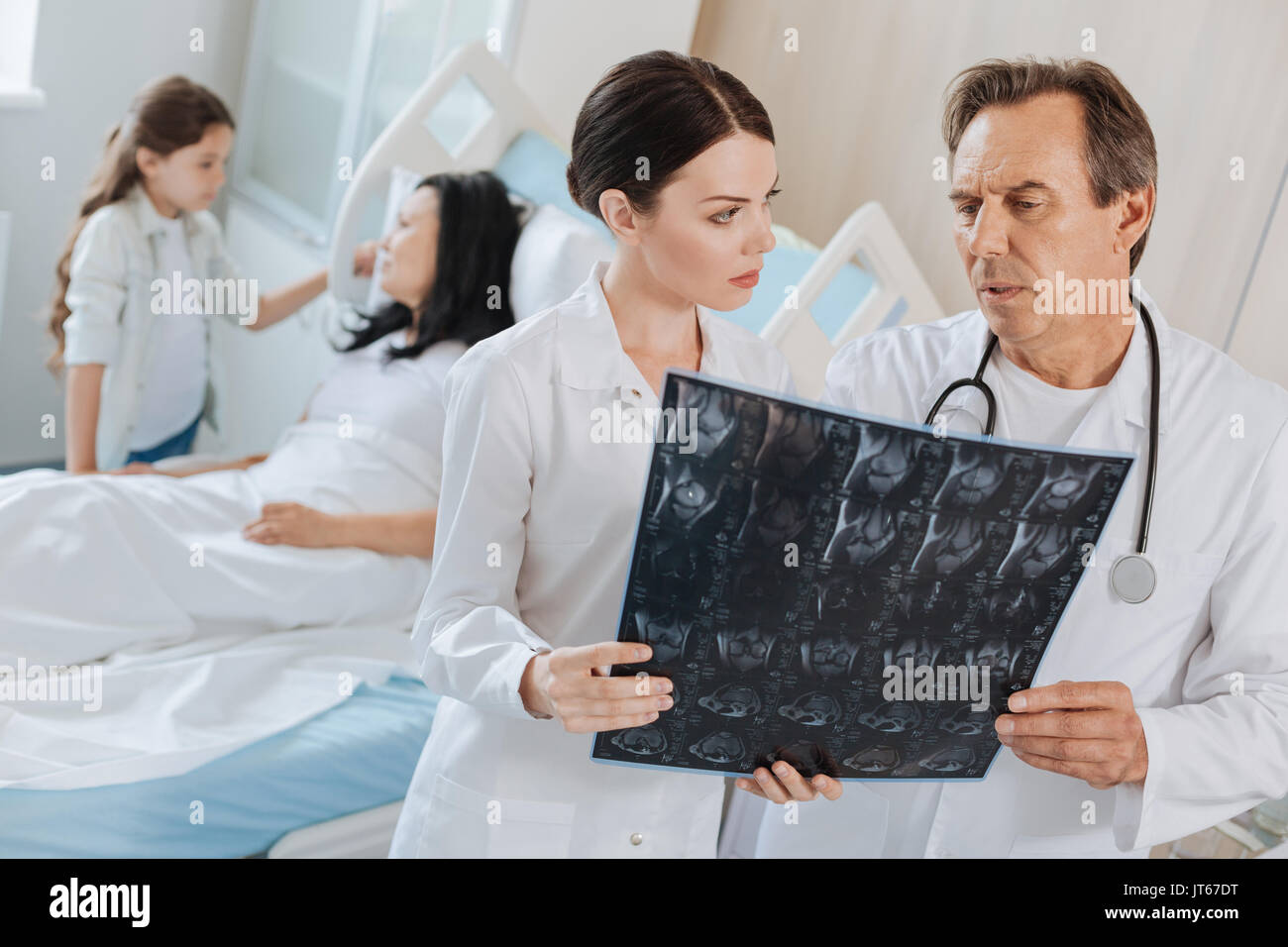 Professional experienced doctors looking at the Xray photo Stock Photo ...