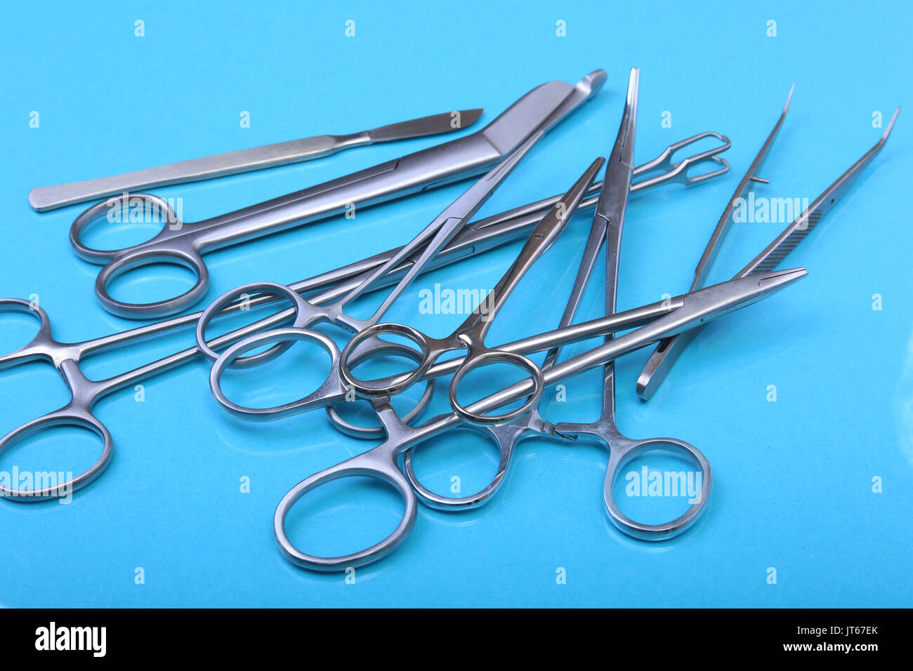 Close Up Surgical instruments and tools on blue mirror background ...