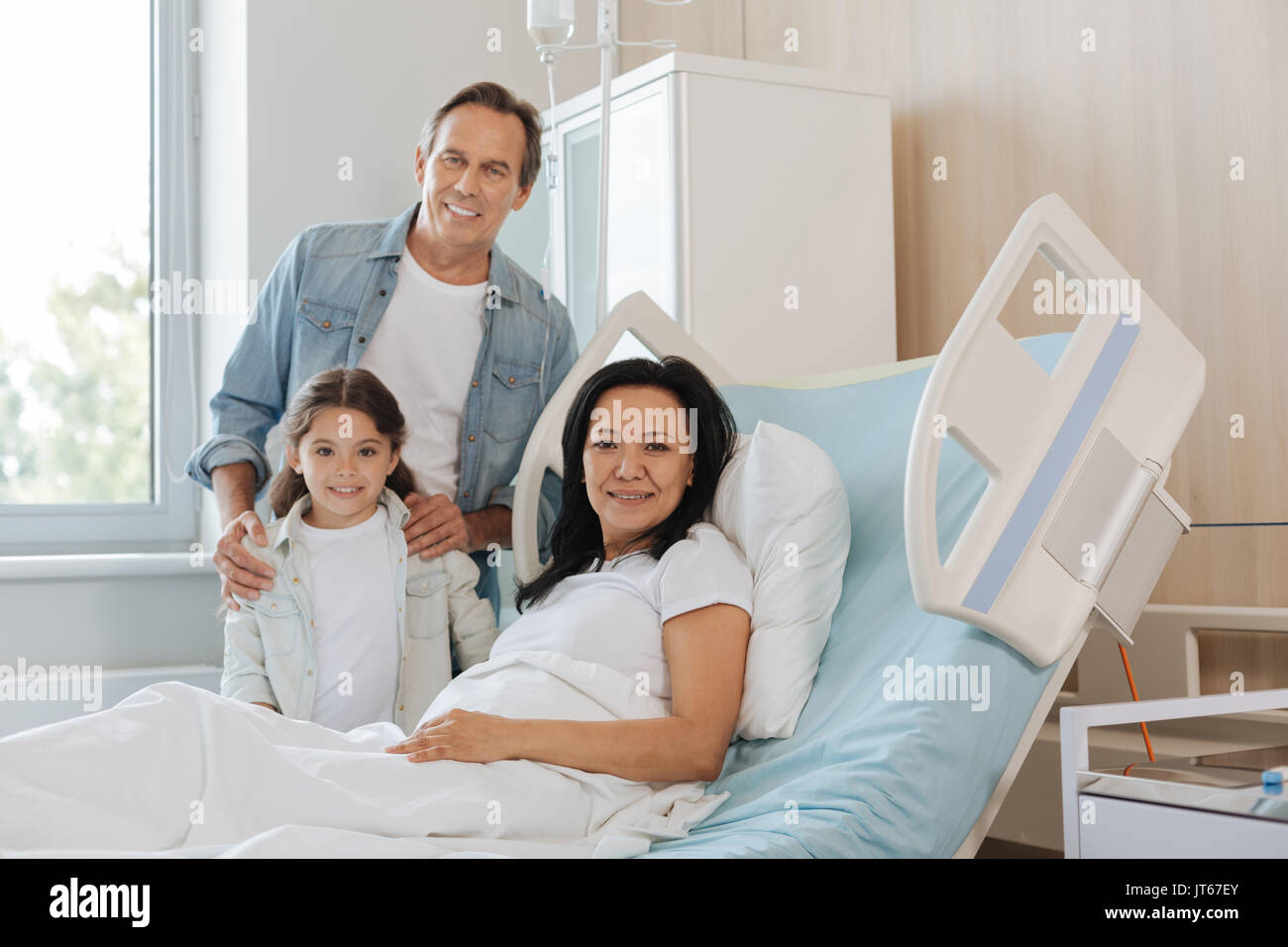 Delighted father and daughter visiting their mom Stock Photo - Alamy
