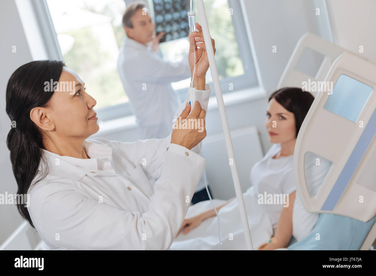Nice professional doctor working with medical equipment Stock Photo - Alamy