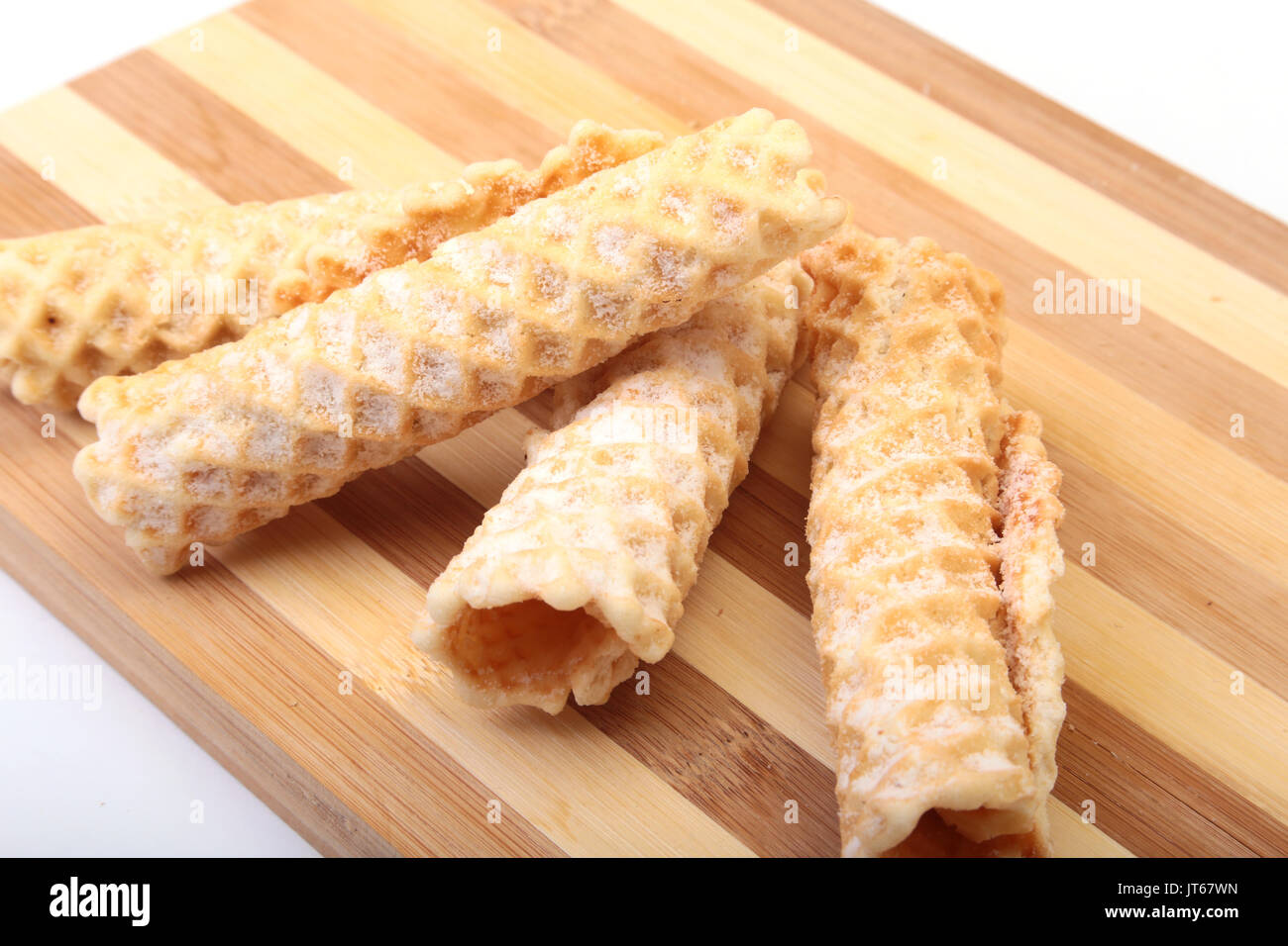 Homemade wafer rolls with powdered sugar isolated on white background ...