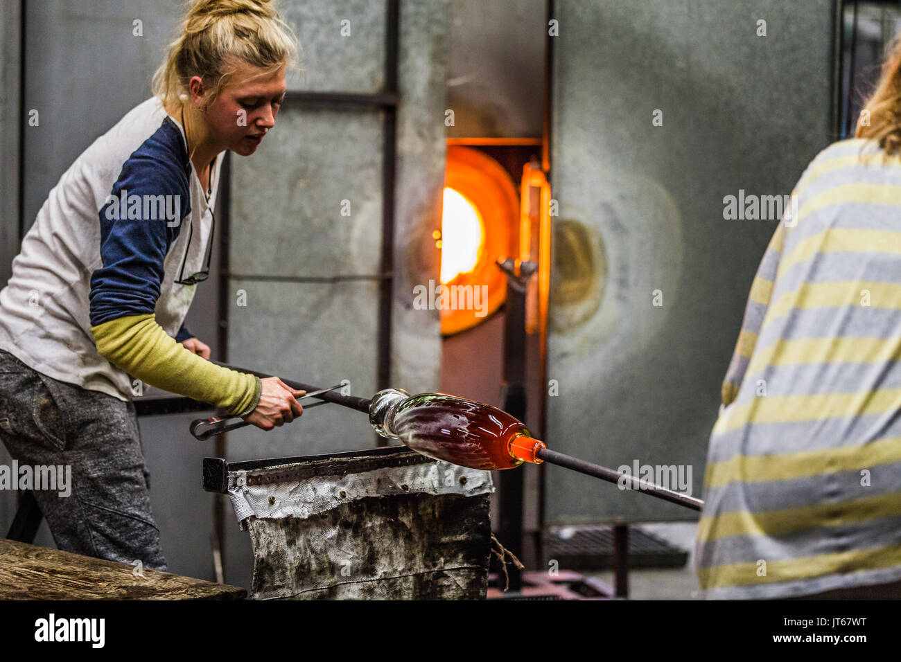 Two Blowing Glass Artists Finishing a beautiful Piece Stock Photo - Alamy