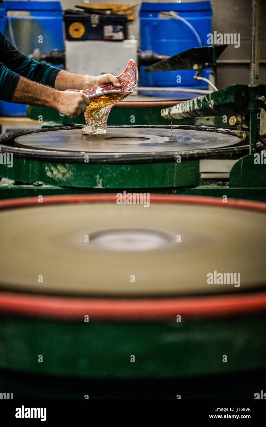 Man Working a Glass Blown Vase on Spinning Silica Sanding Disk Stock ...