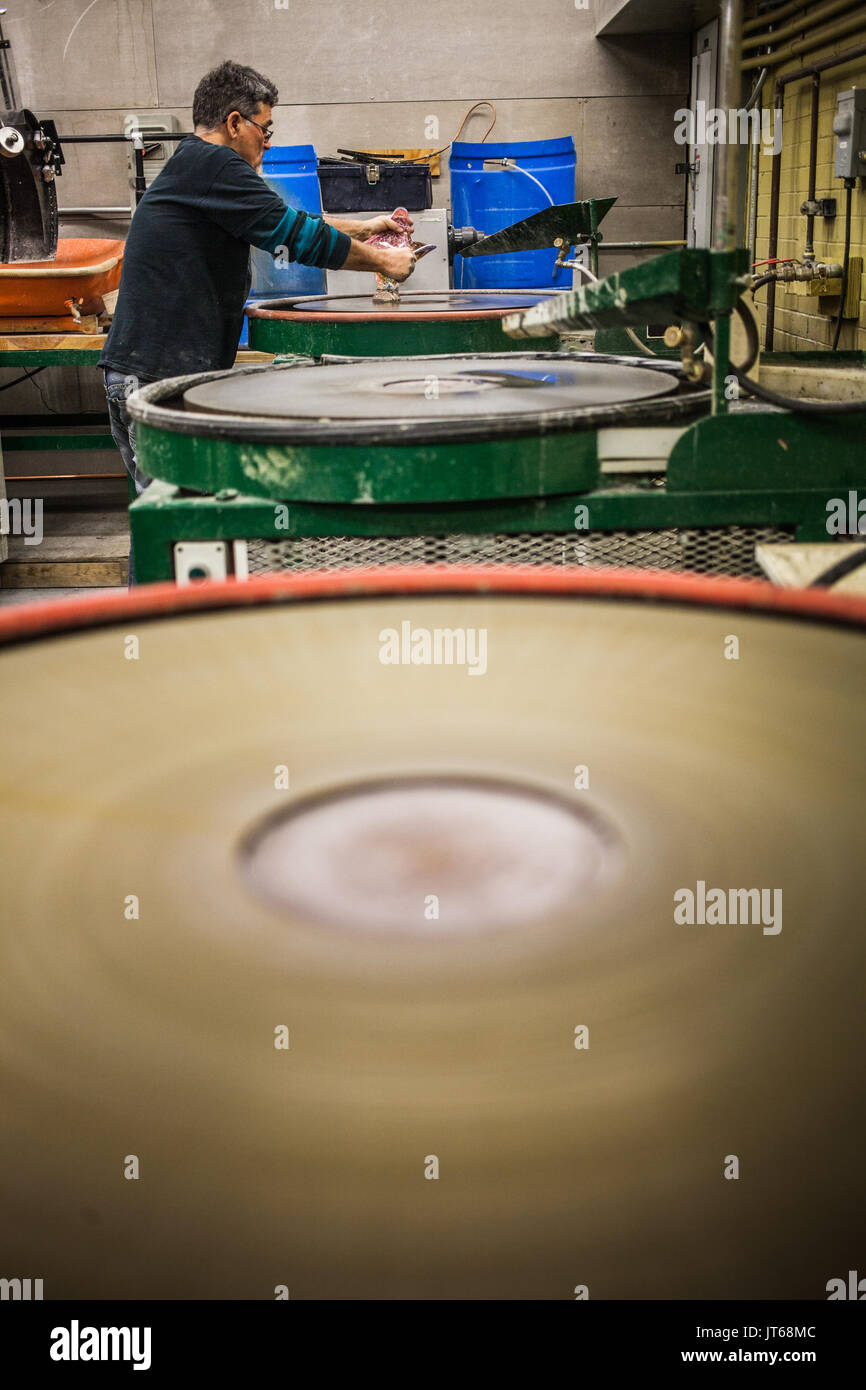 Man Working a Glass Blown Vase on Spinning Silica Sanding Disk Stock ...