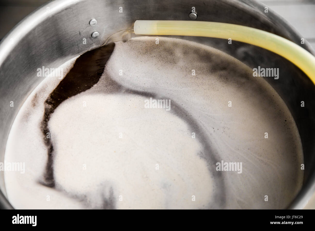 Pouring Craft Home Brew Beer Wort into the Boil Kettle with a Silicone ...