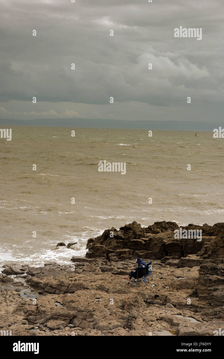 The brown colour of the Bristol Channel at low tide with rocks in the ...