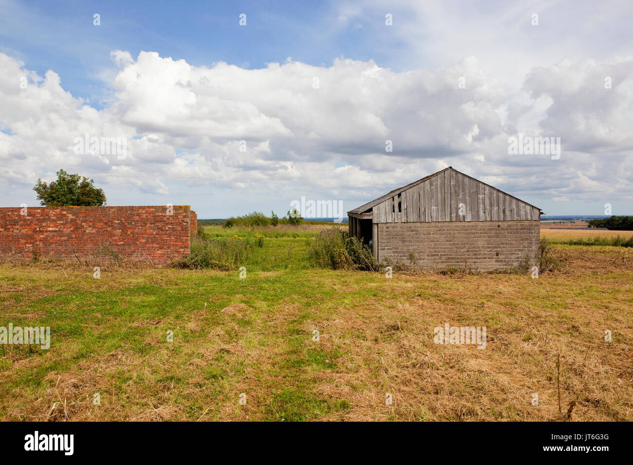 old farm buildings and barn overlooking the vale of york under a smmer ...