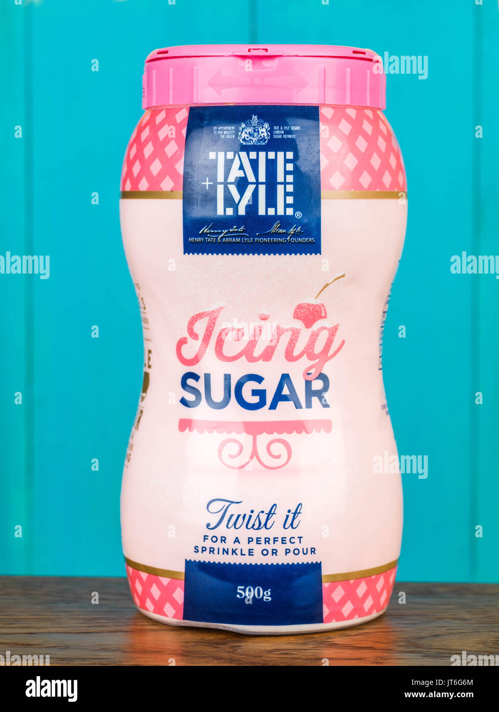 Tate + Lyle Icing Sigar Plastic Branded Container Against a Blue Wooden ...