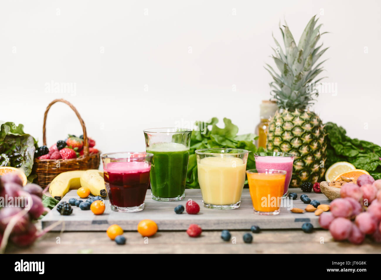 Five glasses of fresh smoothies (in all different colors) are ...