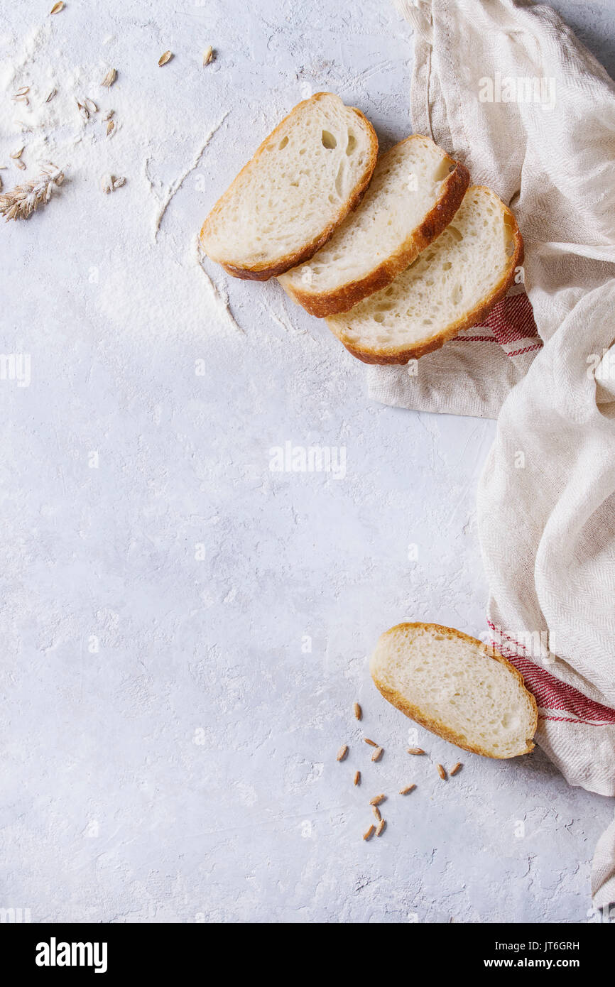Homemade white wheat bread slice served with flour and wheat grain ...