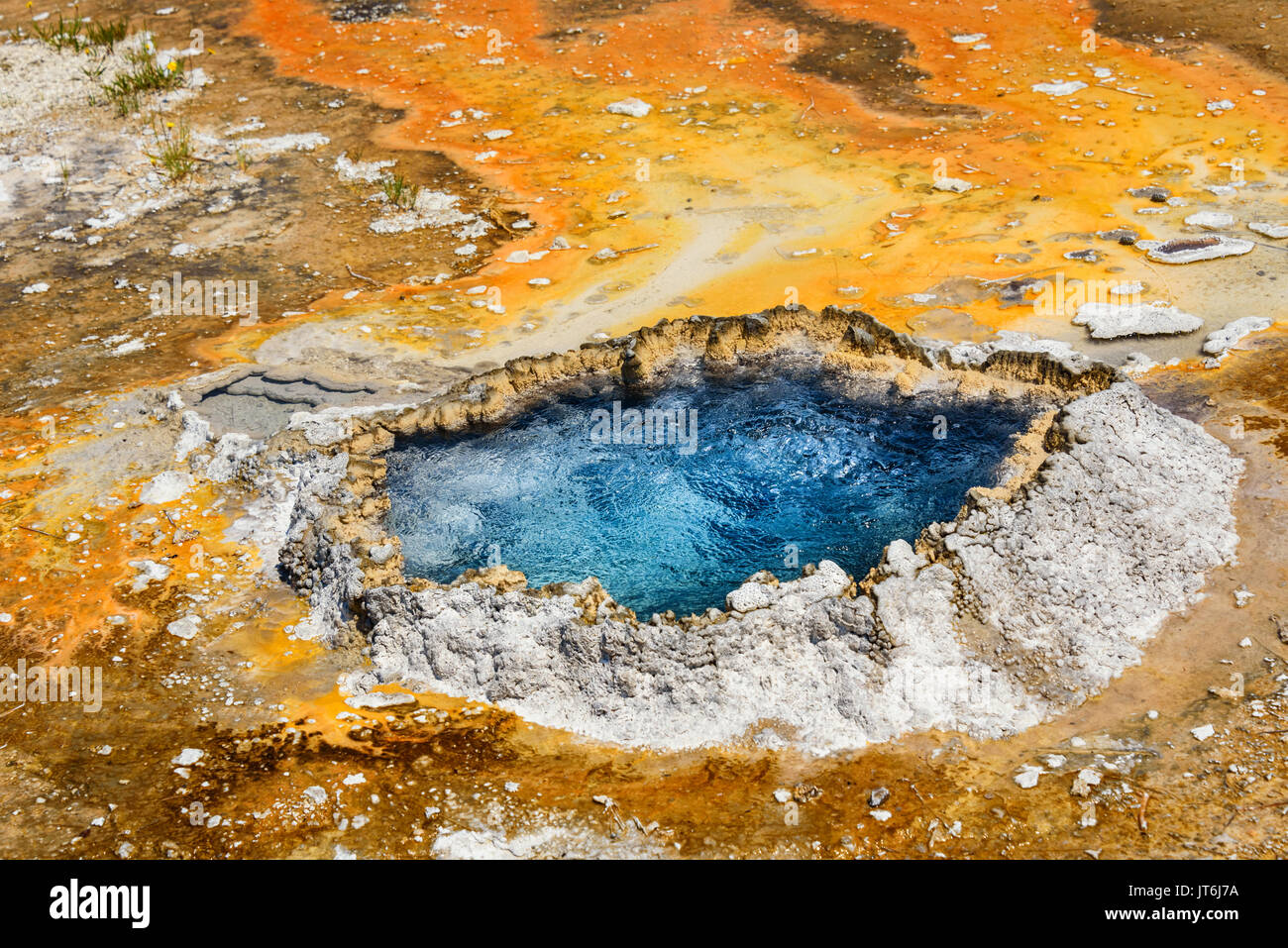 Closeup of a crater with blue boiling water. Hot spring, pool, geyser ...