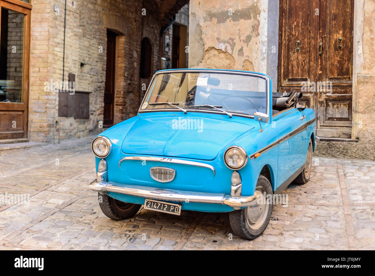 An italian vintage car parked in a street of the historical center of ...