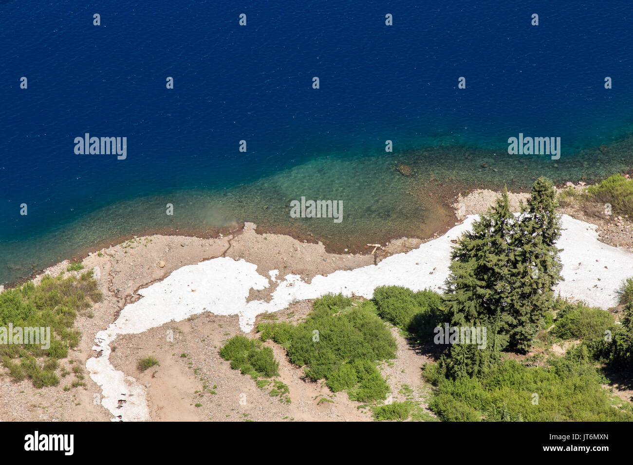 Crater Lake sandy beach with snow Stock Photo - Alamy