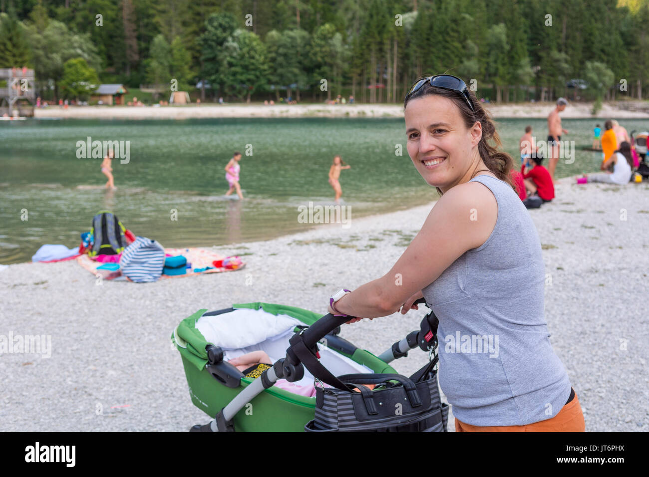 Happy mother pushing a baby stroller Stock Photo - Alamy