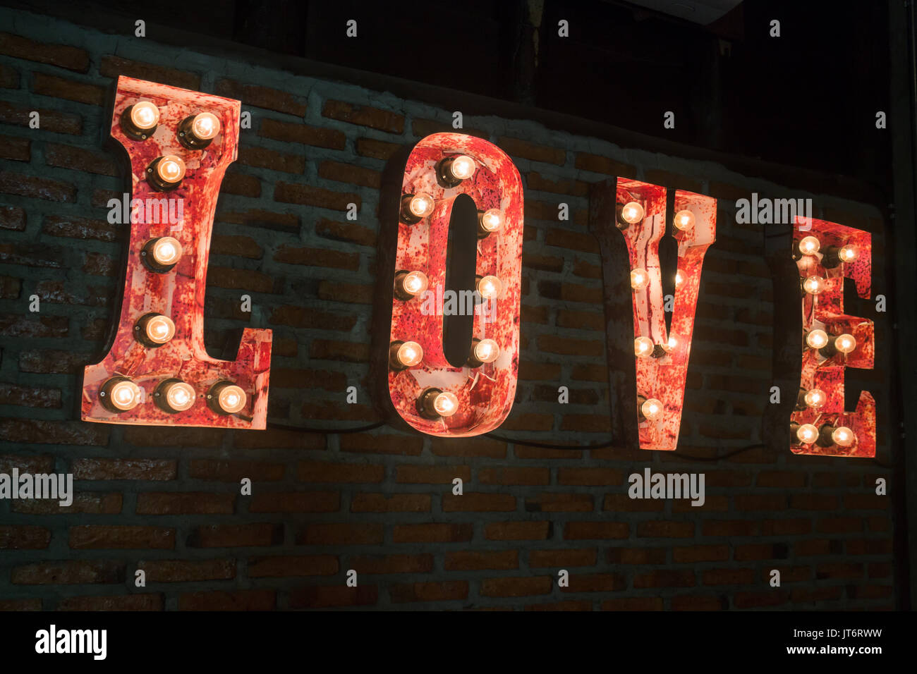 LOVE bulb sign decorated on brick wall, stock photo Stock Photo - Alamy