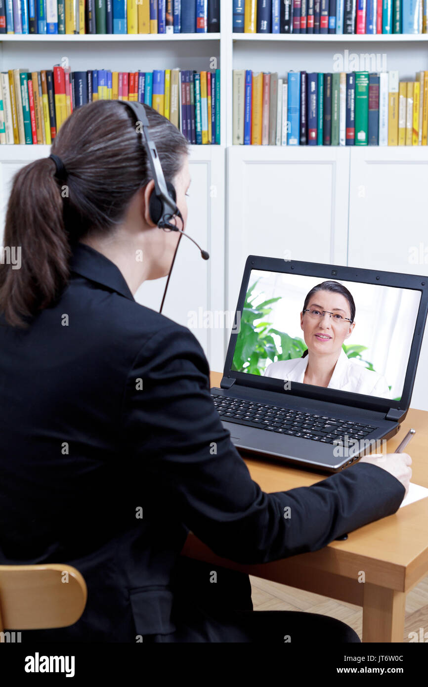 Female member of the staff department in her office with computer and ...
