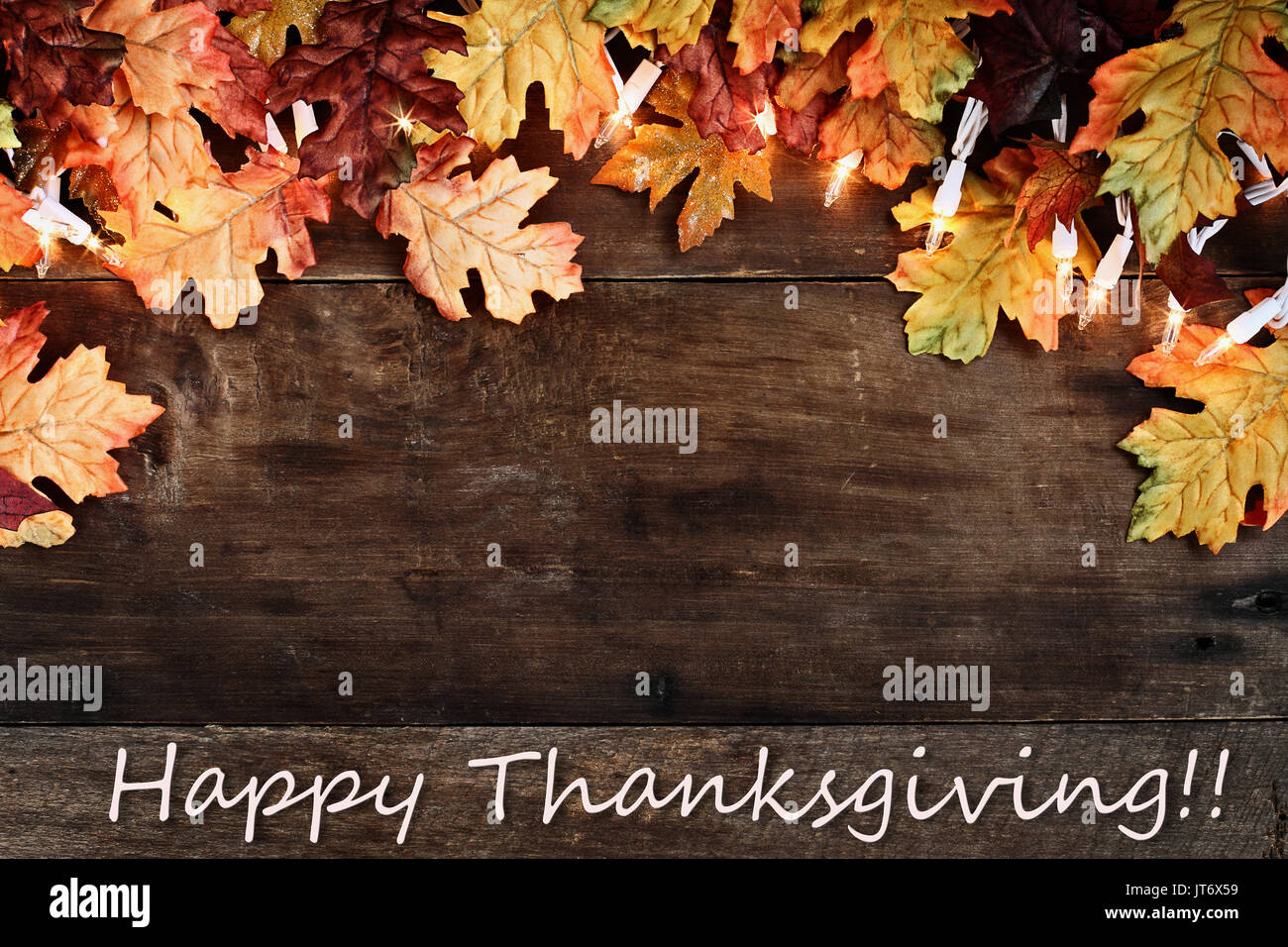 Rustic fall background of autumn leaves and decorative lights with ...