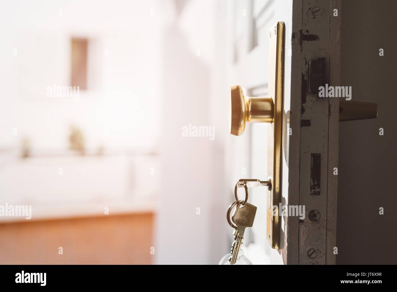 Door key in keyhole on old white wooden doors Stock Photo - Alamy