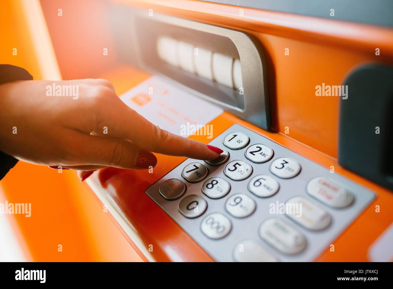Woman entering pin code on the ATM keypad Stock Photo - Alamy