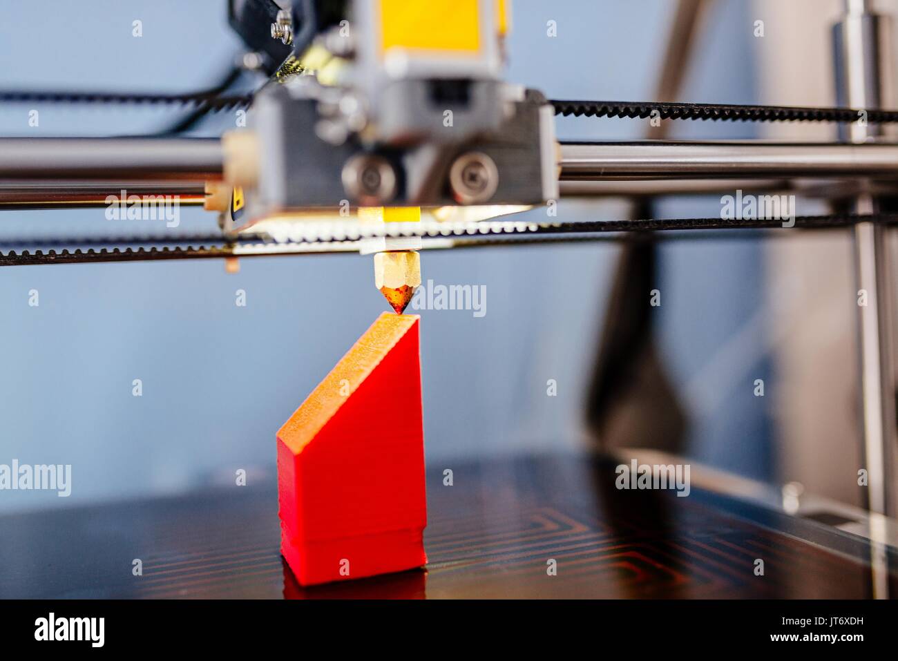 3d printer working and printing red plastic component Stock Photo - Alamy