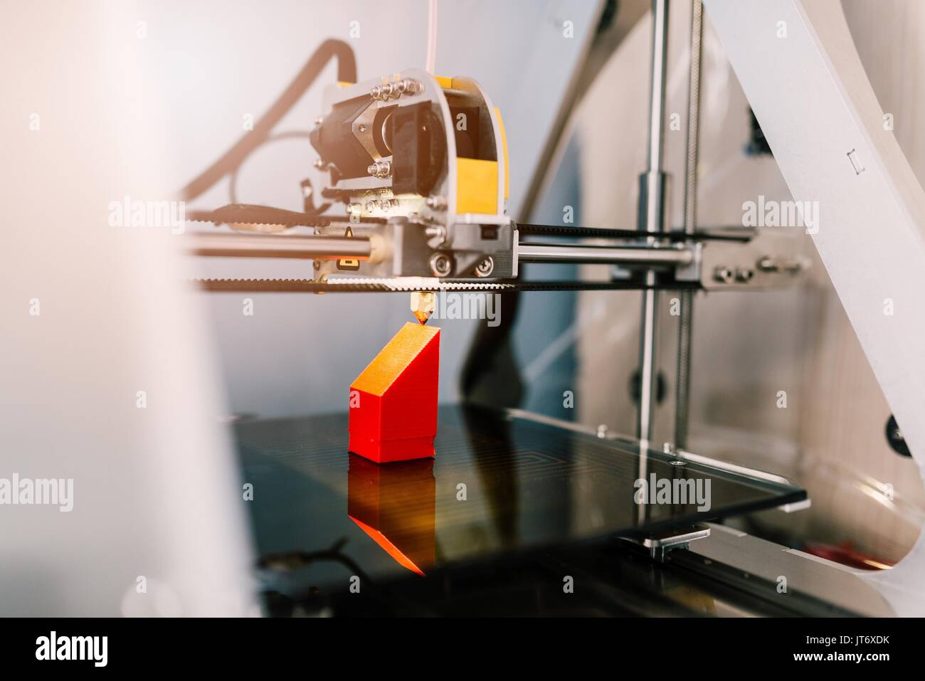 3d printer working and printing red plastic component Stock Photo - Alamy
