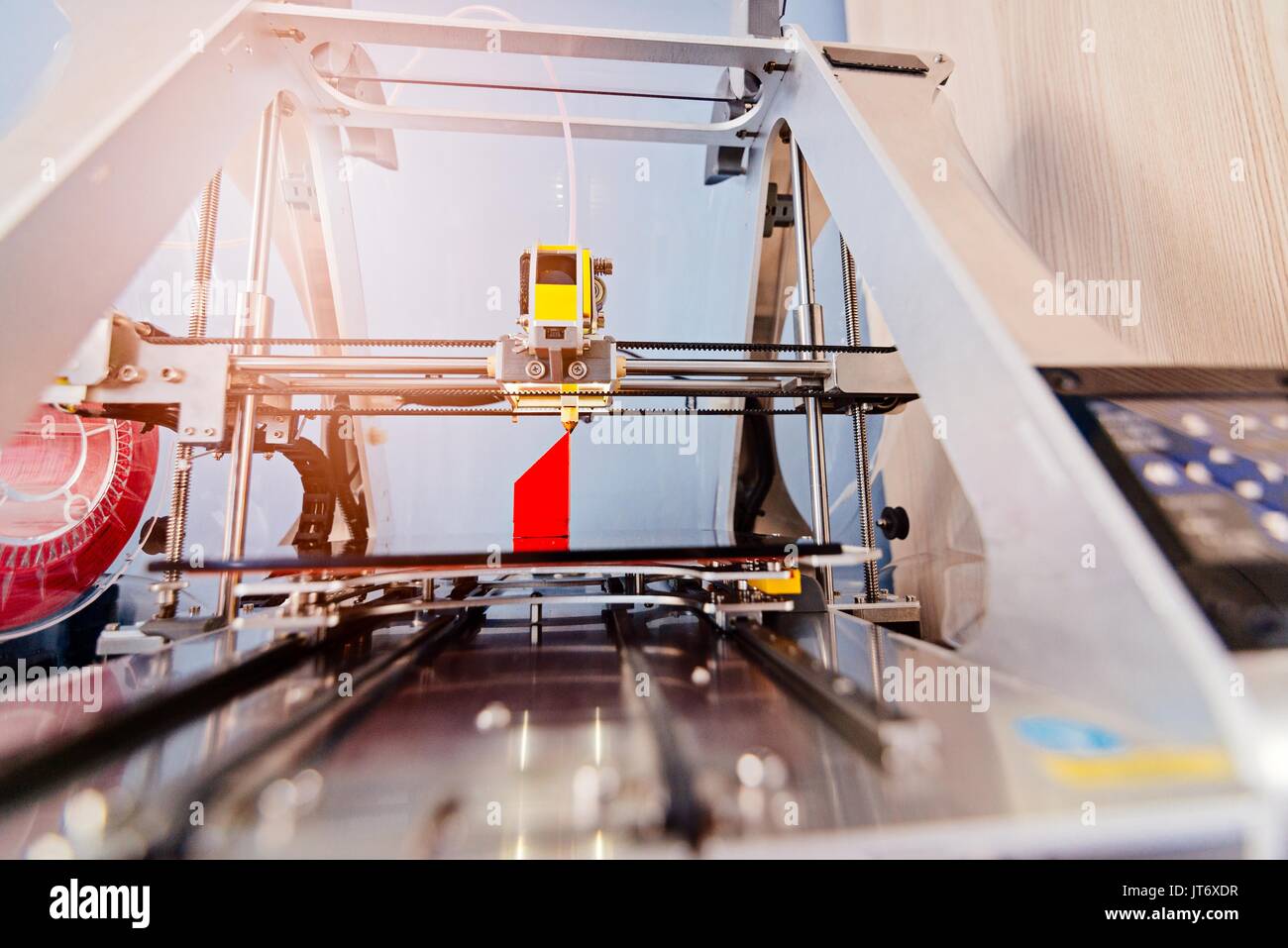 3d printer working and printing red plastic component Stock Photo - Alamy