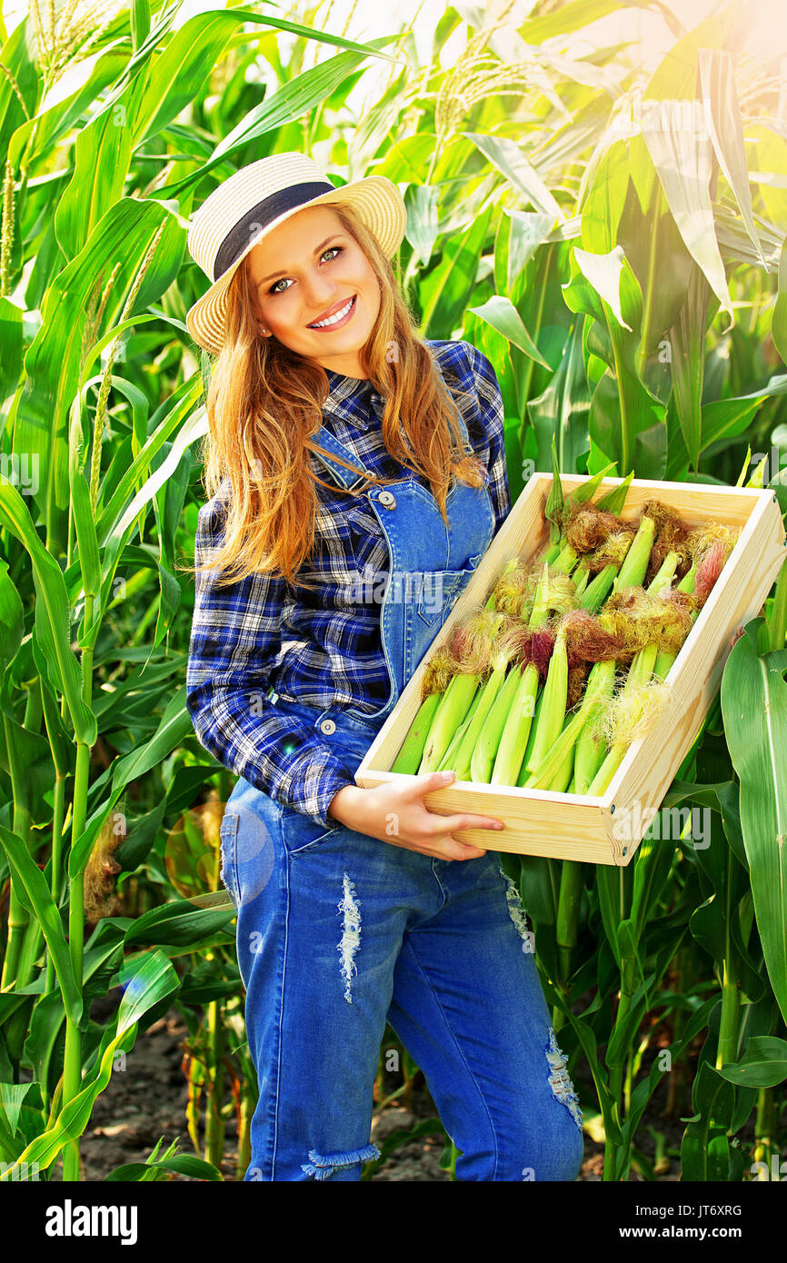 Farming concept. Portrait of young and beautiful red haired girl in hat ...