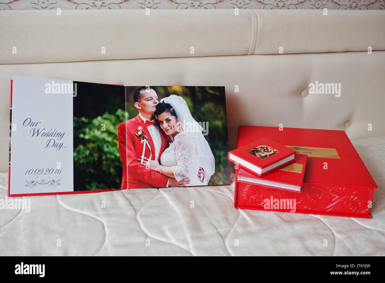 Pages of elegant red wedding photobook or photoalbum on the soft beige ...
