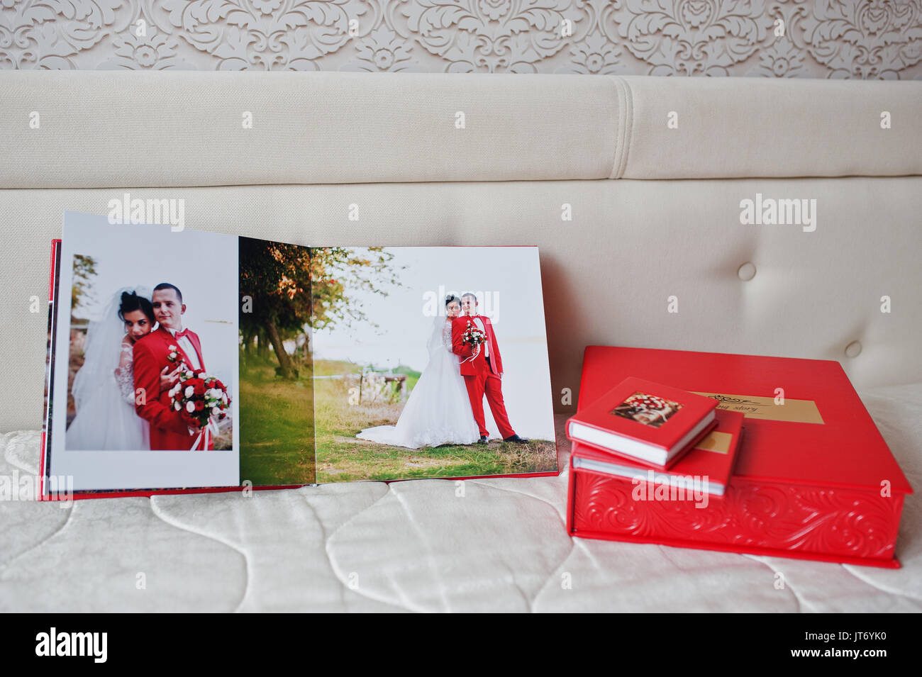 Pages of elegant red wedding photobook or photoalbum on the soft beige ...