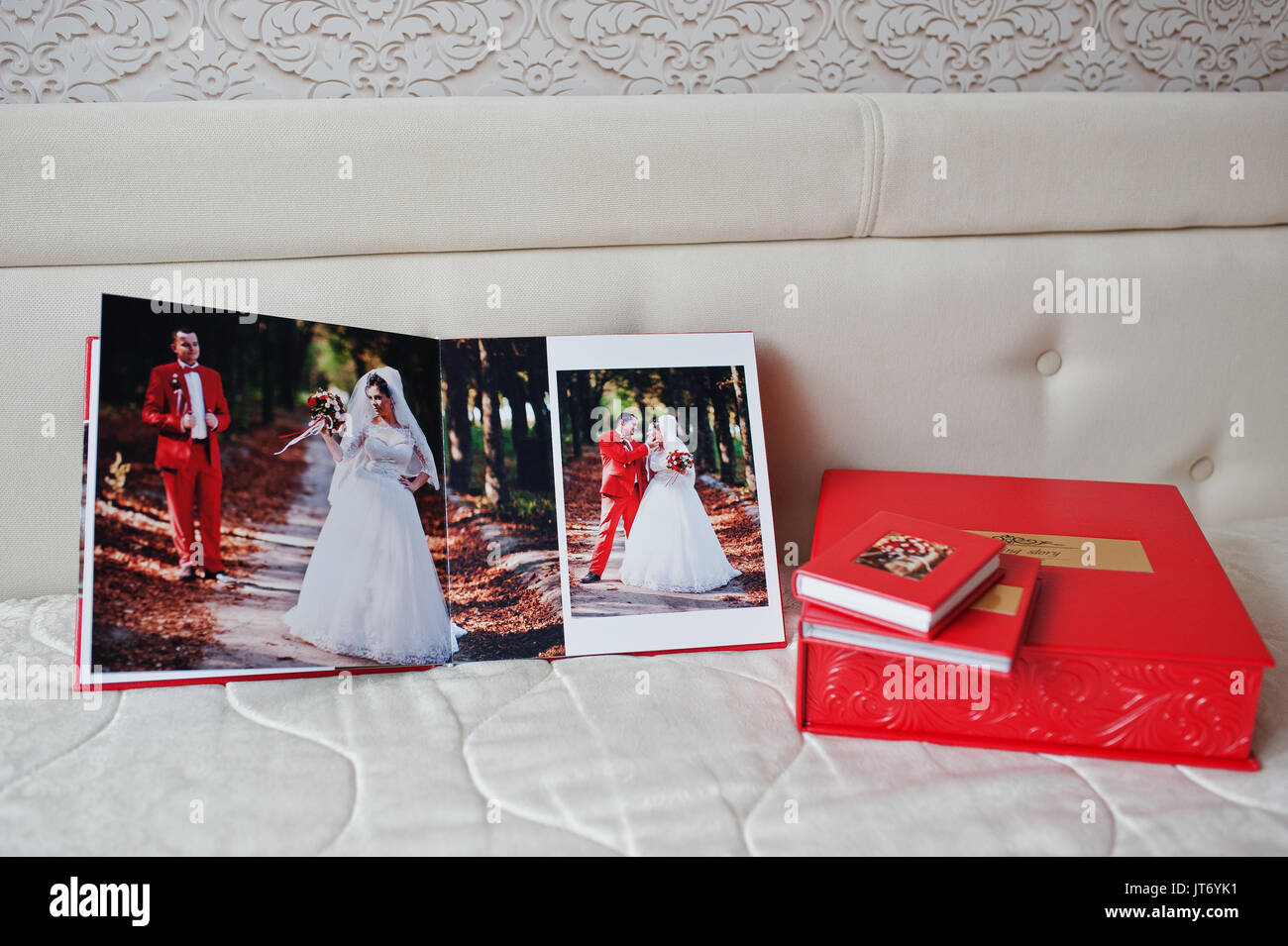 Pages of elegant red wedding photobook or photoalbum on the soft beige ...