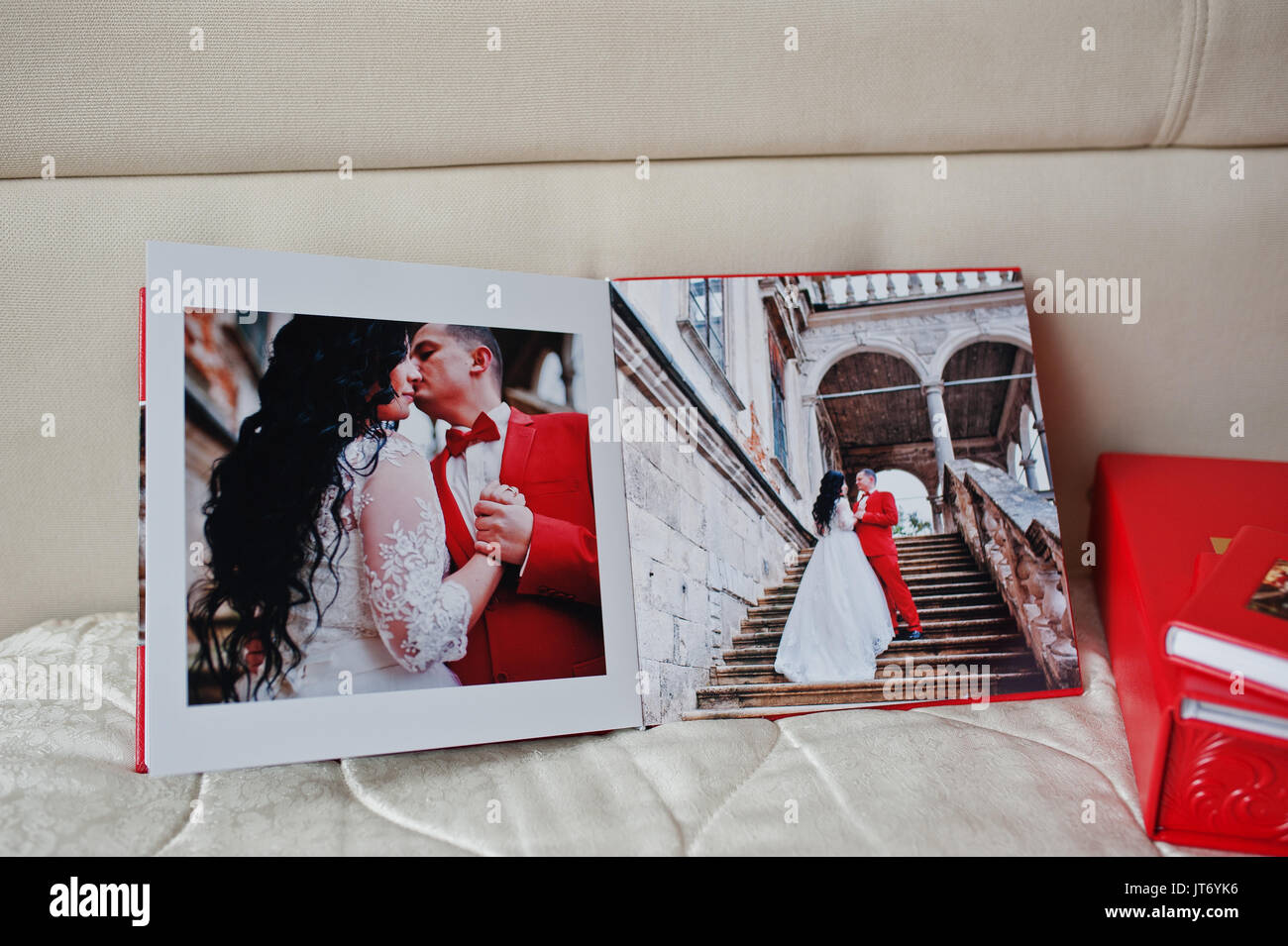 Pages of elegant red wedding photobook or photoalbum on the soft beige ...