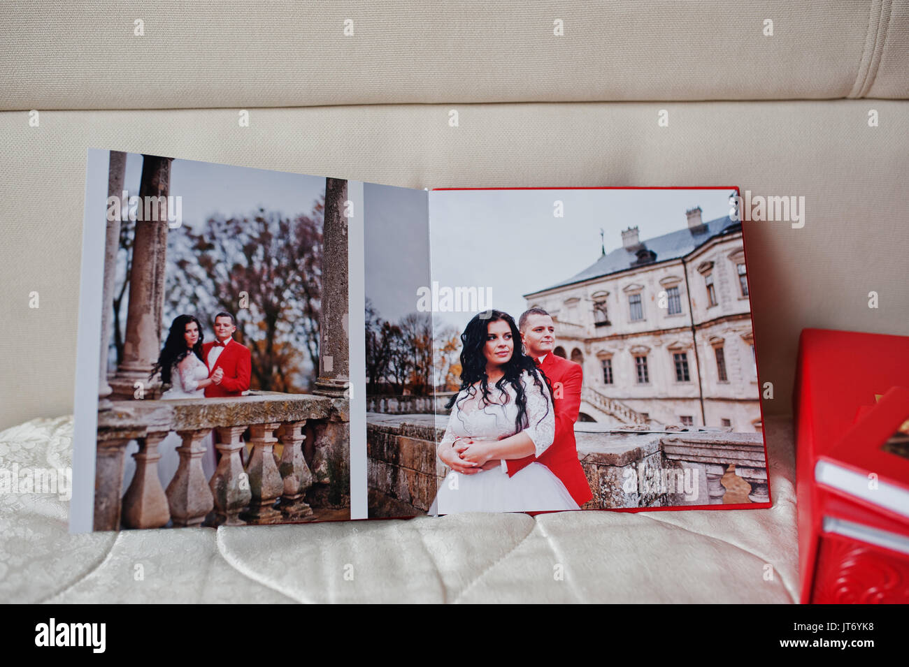 Pages of elegant red wedding photobook or photoalbum on the soft beige ...