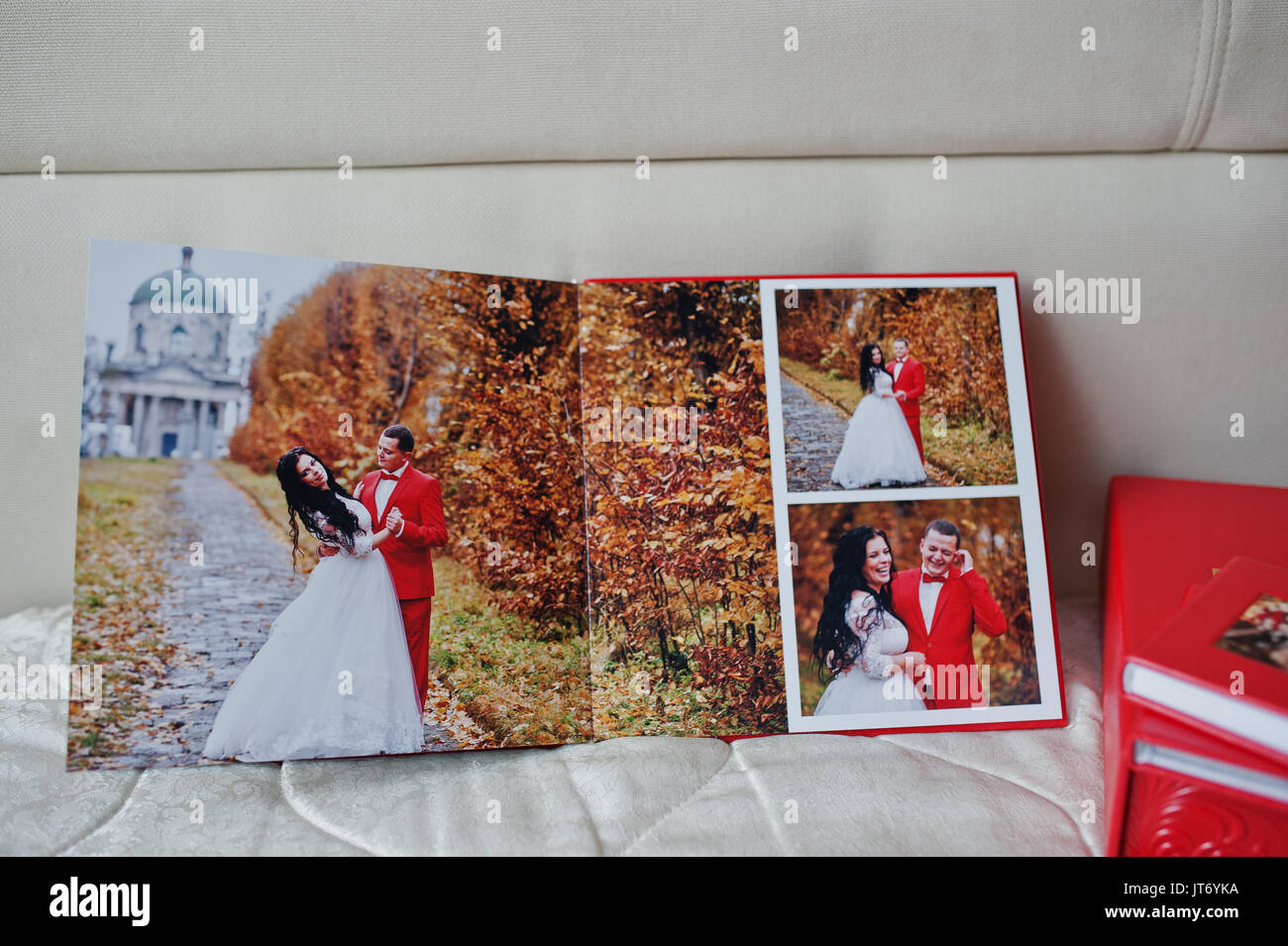 Pages of elegant red wedding photobook or photoalbum on the soft beige ...