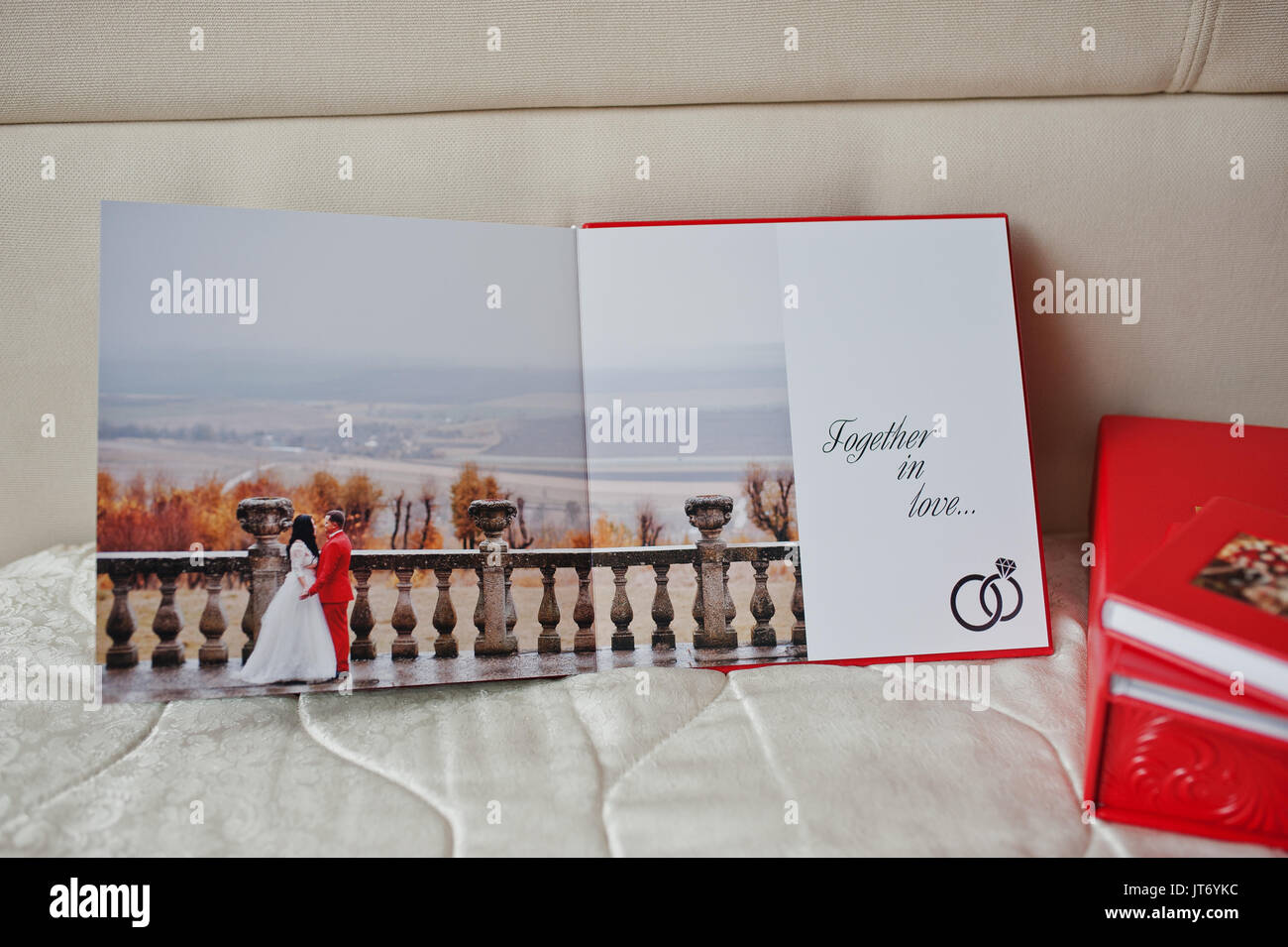 Pages of elegant red wedding photobook or photoalbum on the soft beige ...