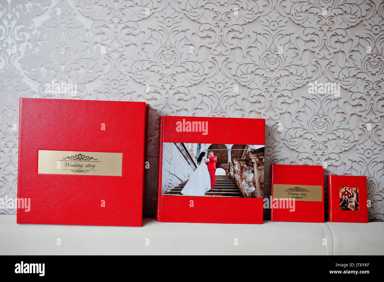 Elegant red wedding photobooks or photo albums with golden inscription ...