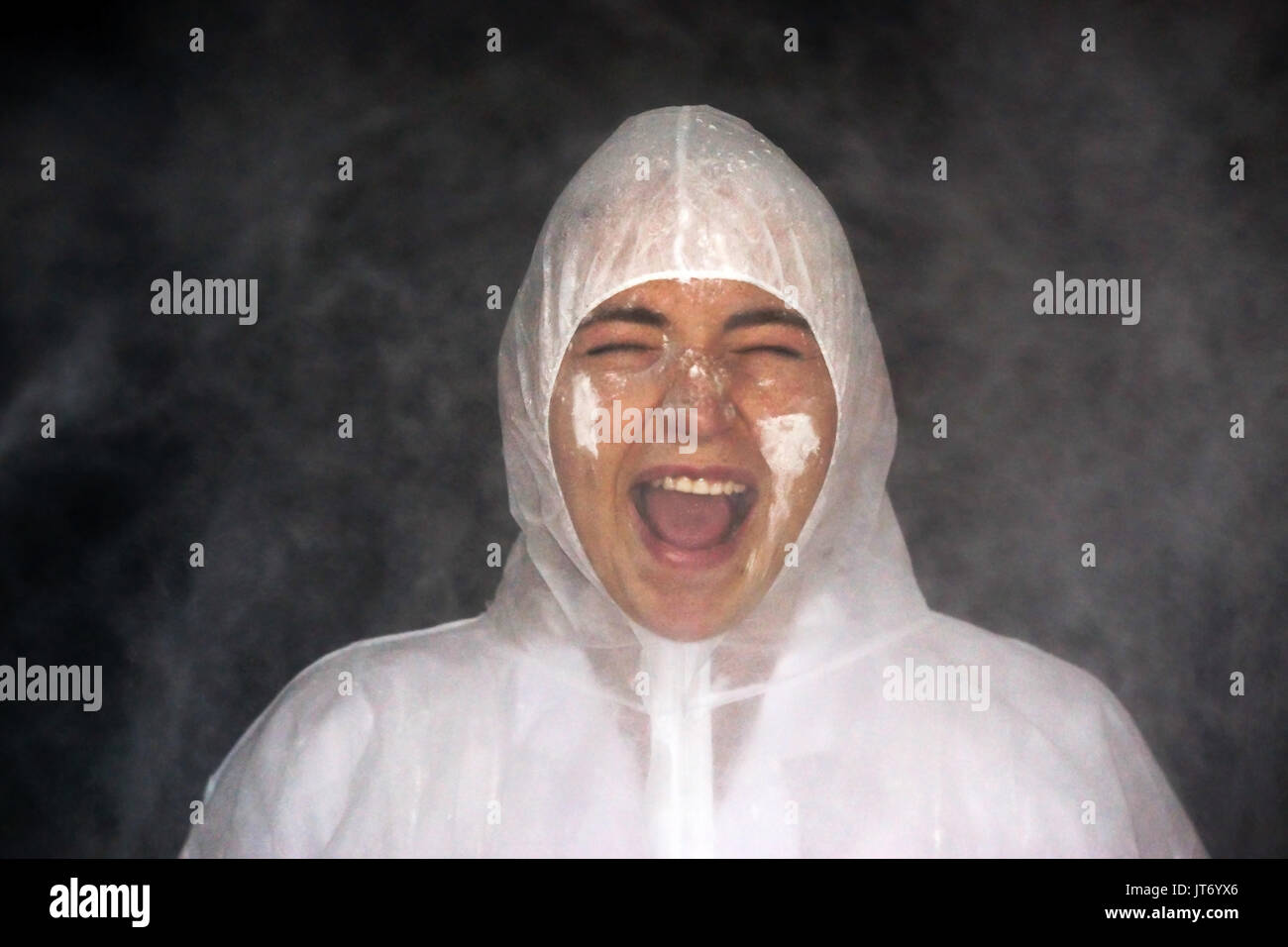 A young female worker wears a disposable dust suit Stock Photo - Alamy