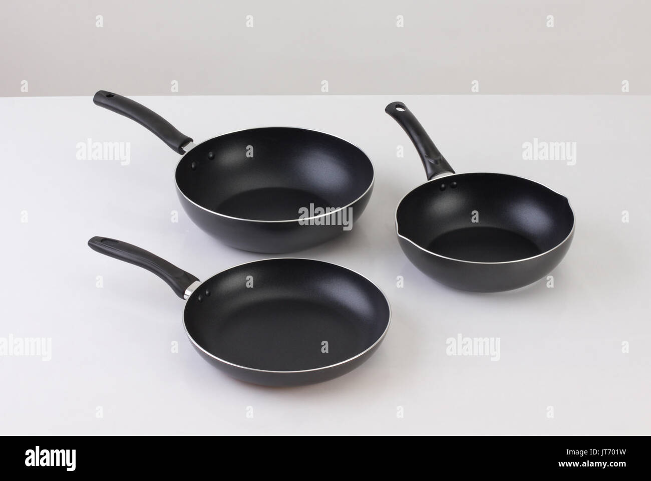 Flying pans with non-stick surface isolated on white background Stock ...