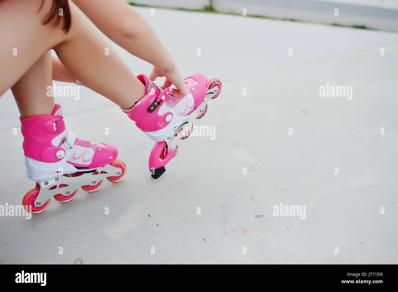 Woman putting on inline hi-res stock photography and images - Alamy