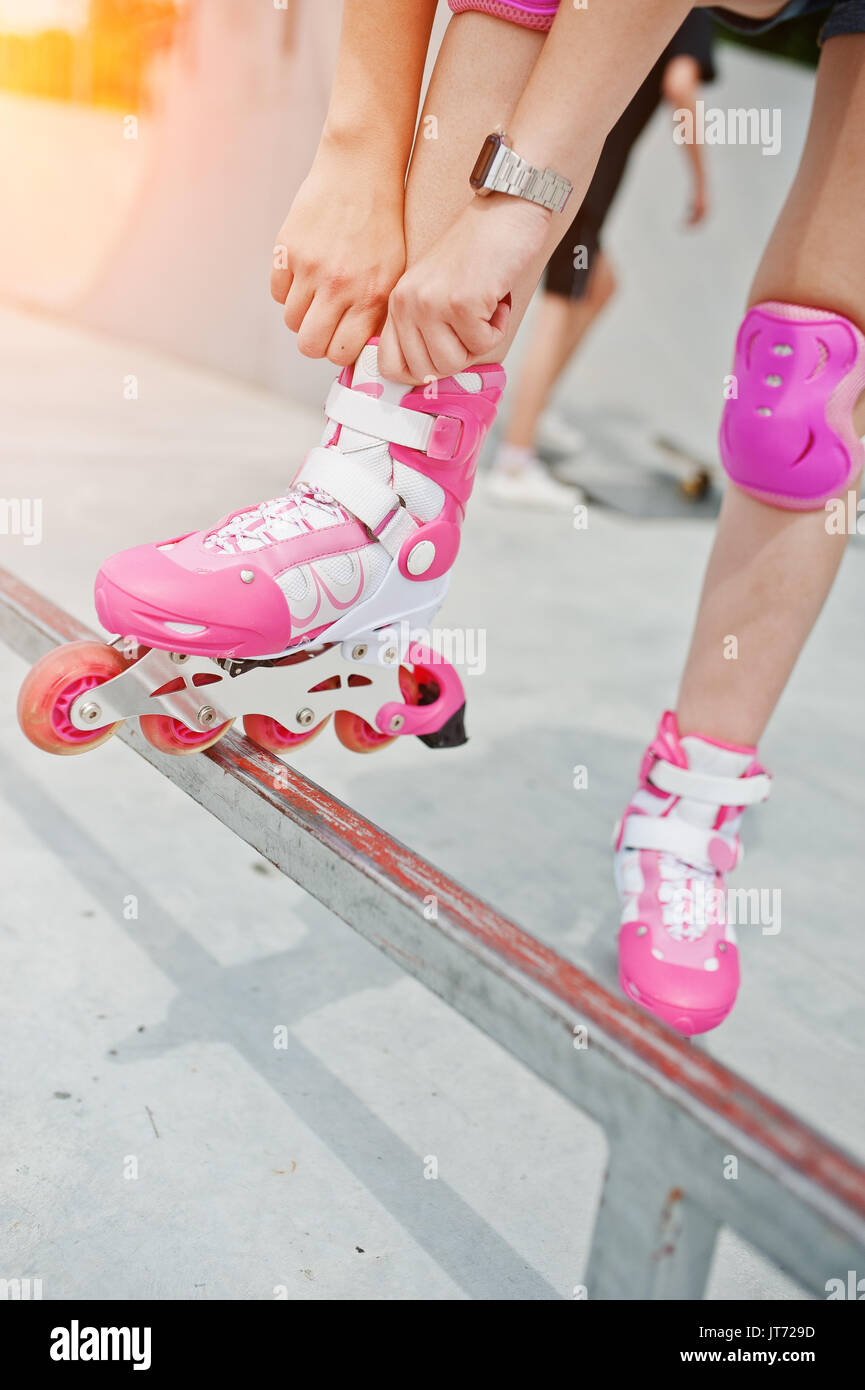 Young woman putting on rollerblades outdoor Stock Photo - Alamy
