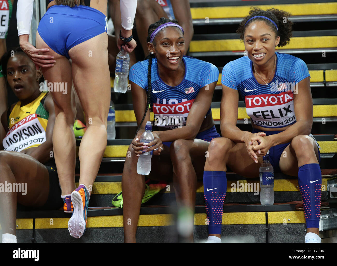 USA's Quanera Hayes (centre) and Allyson Felix (right) take a break ...