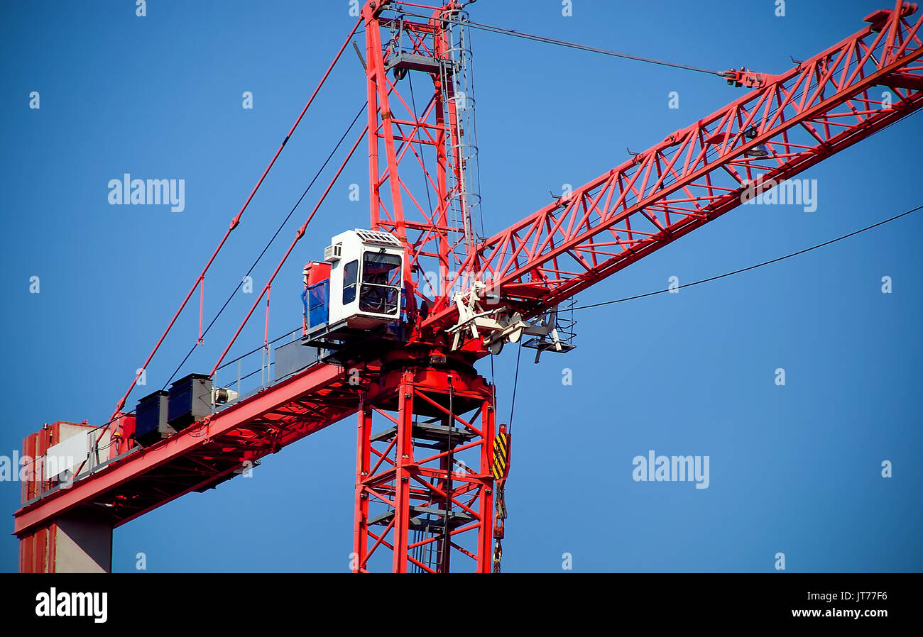 Cranes on site with boom high in sky Stock Photo - Alamy