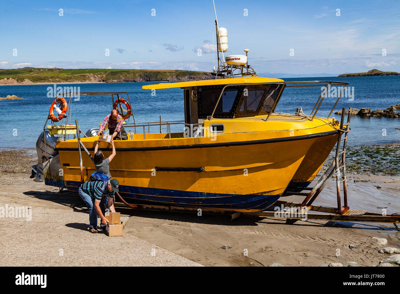 Yellow tractor pulling boat hi-res stock photography and images - Alamy