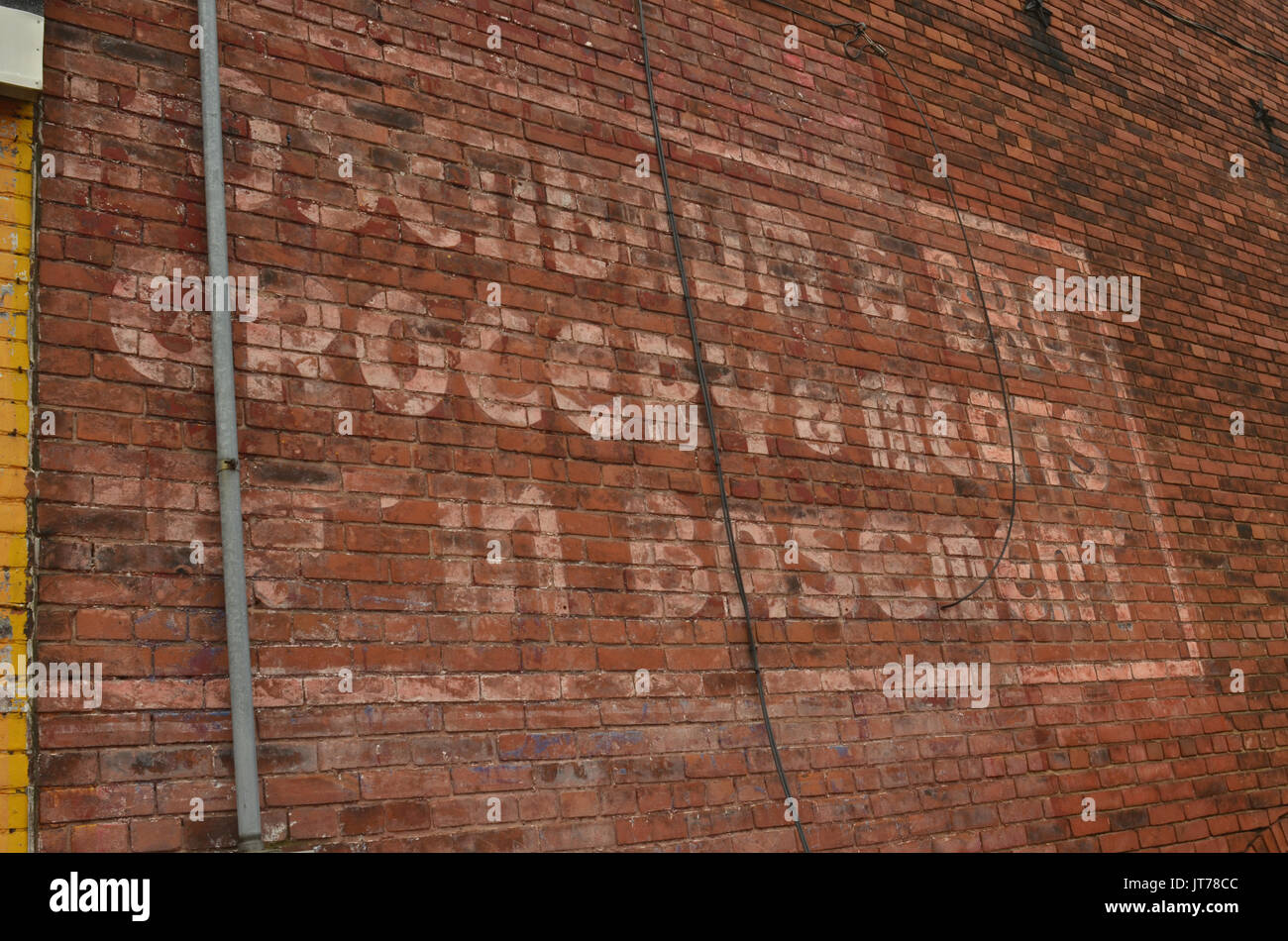 vintage painted sign on old brick building Stock Photo - Alamy