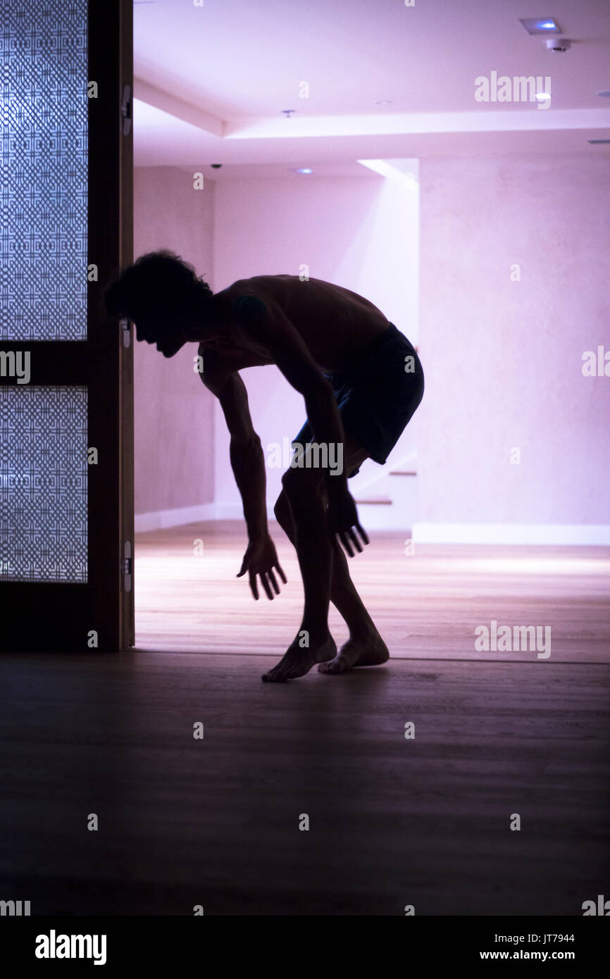 Male yoga teacher doing handstand calisthenics and yoga asana practice ...